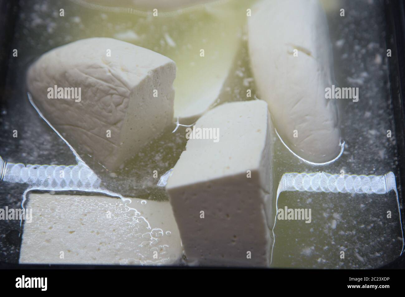 White cheese cut into pieces in the water Stock Photo - Alamy