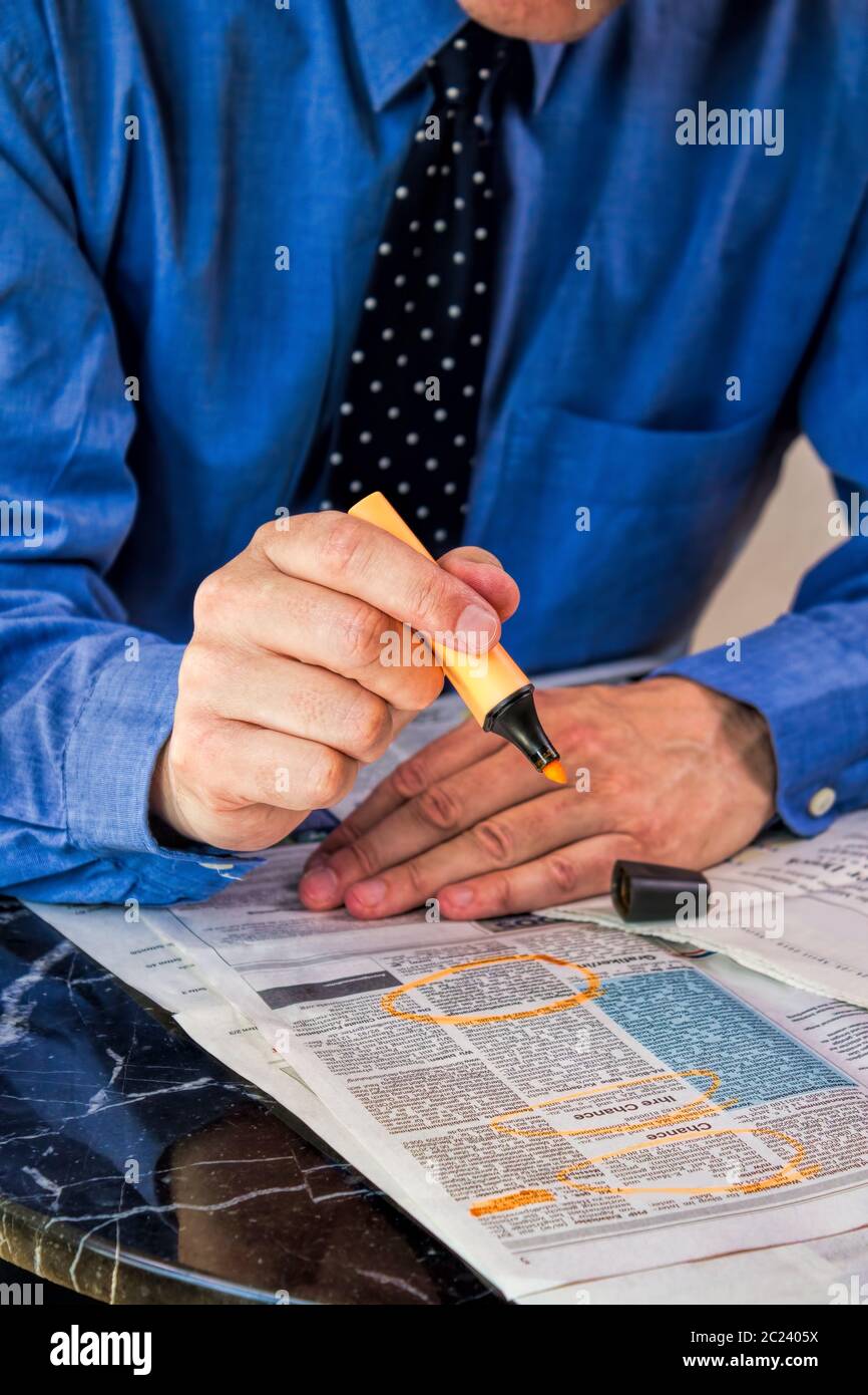 Man posts job offers in a newspaper Stock Photo - Alamy