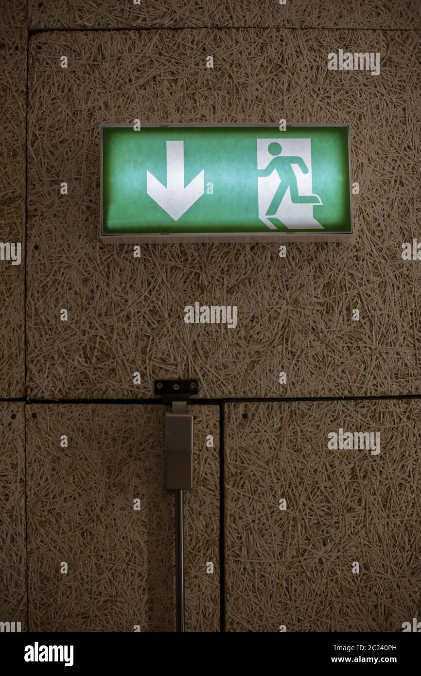 Color image of a green exit sign above a door Stock Photo - Alamy