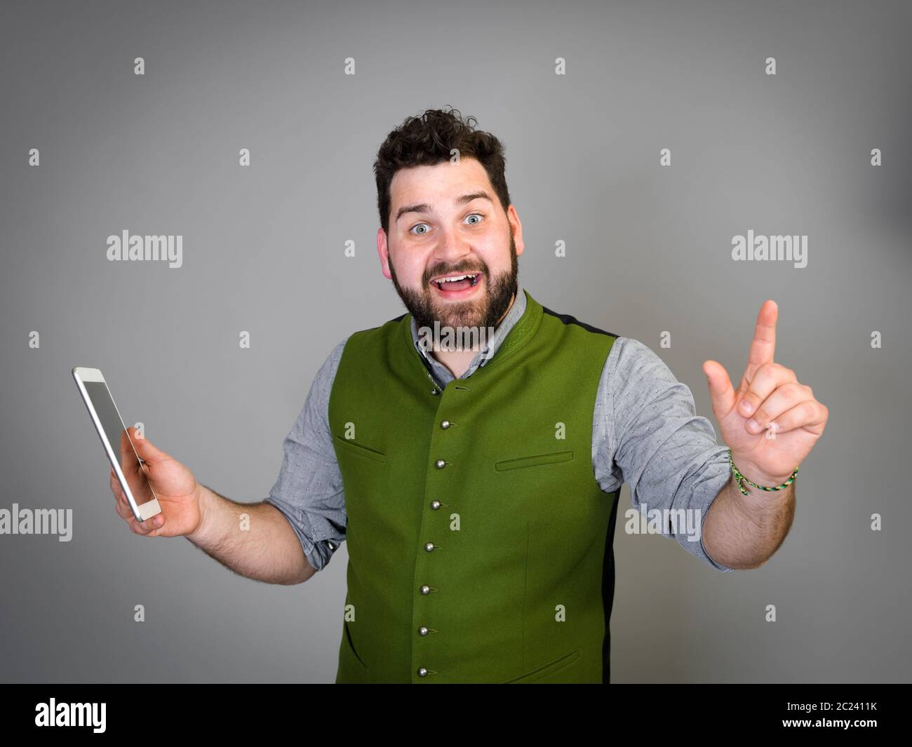 young and cool austrian man with black hair and beard in traditional ...