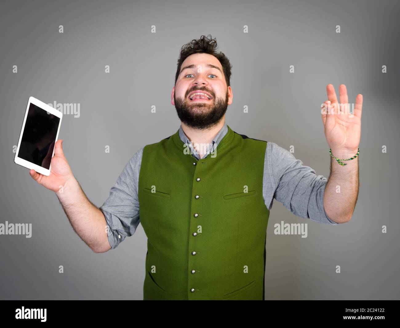 young and cool austrian man with black hair and beard in traditional ...