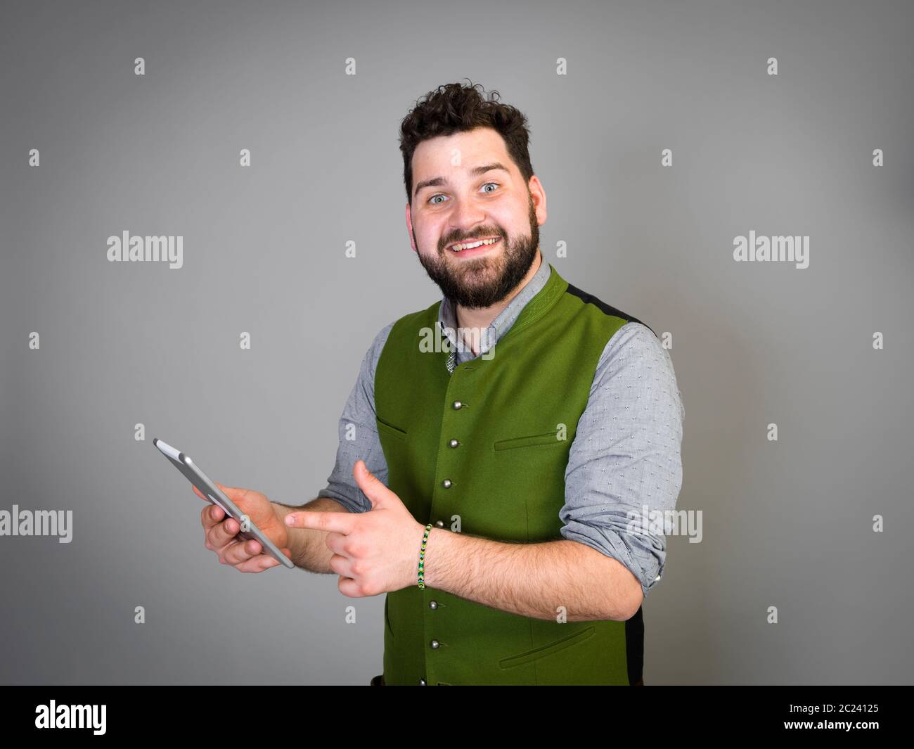 young and cool austrian man with black hair and beard in traditional ...