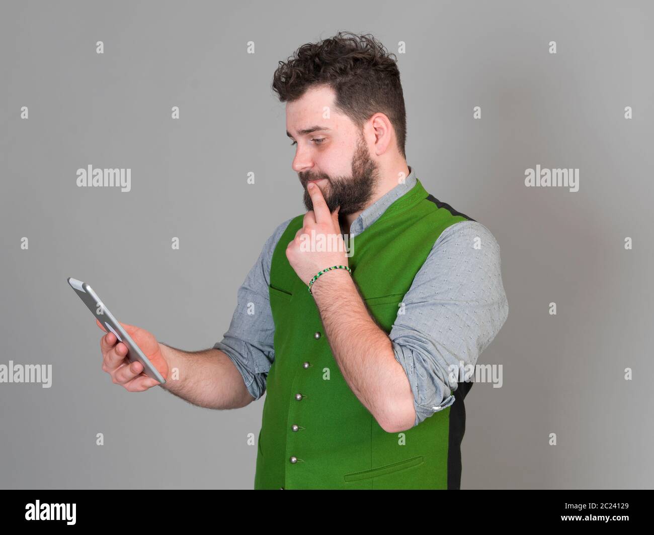 young and cool austrian man with black hair and beard in traditional ...