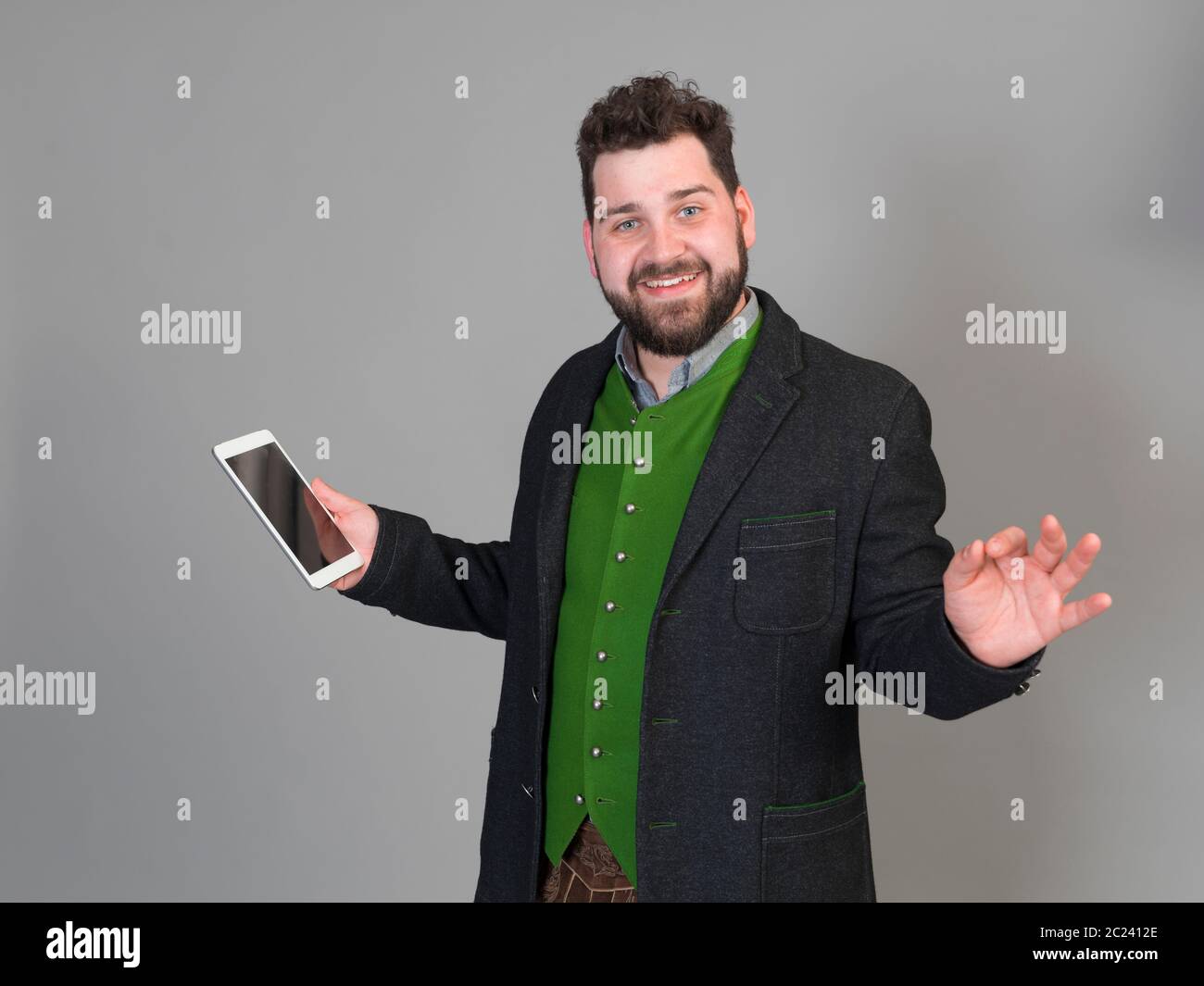 young and cool austrian man with black hair and beard in traditional ...
