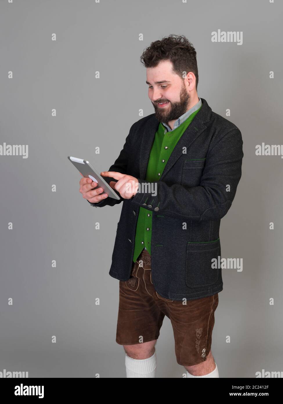 young and cool austrian man with black hair and beard in traditional ...