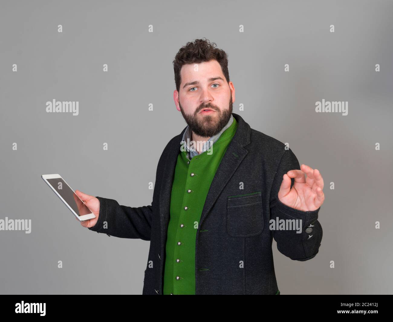 young and cool austrian man with black hair and beard in traditional ...