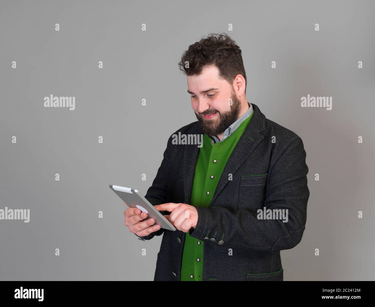 young and cool austrian man with black hair and beard in traditional ...
