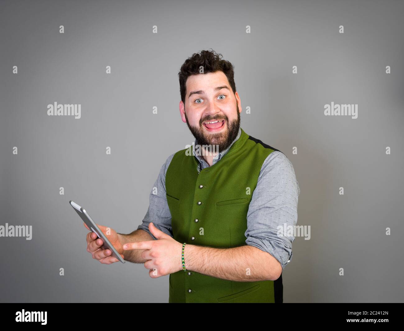 young and cool austrian man with black hair and beard in traditional ...