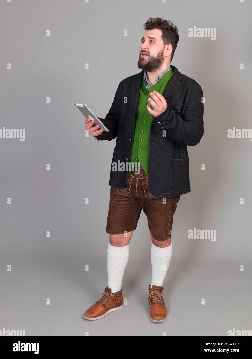 young and cool austrian man with black hair and beard in traditional ...
