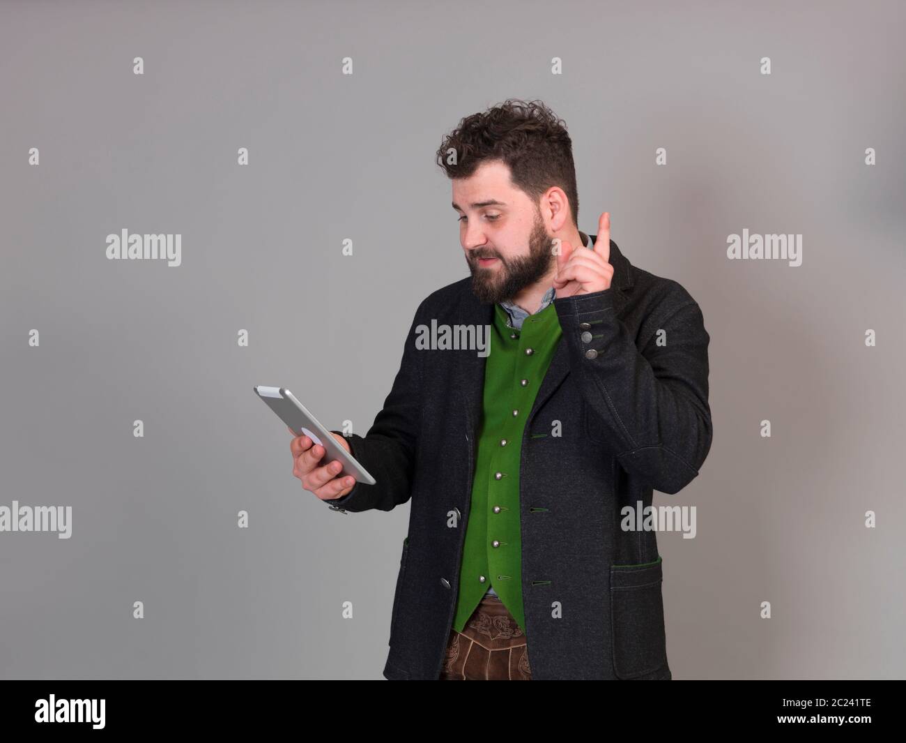 young and cool austrian man with black hair and beard in traditional ...