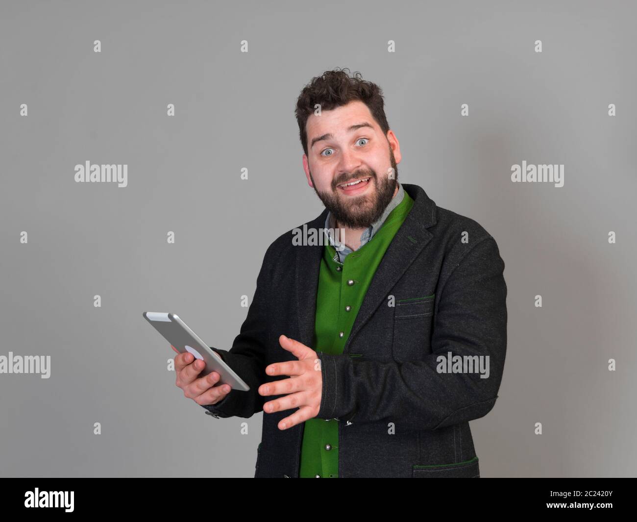 young and cool austrian man with black hair and beard in traditional ...