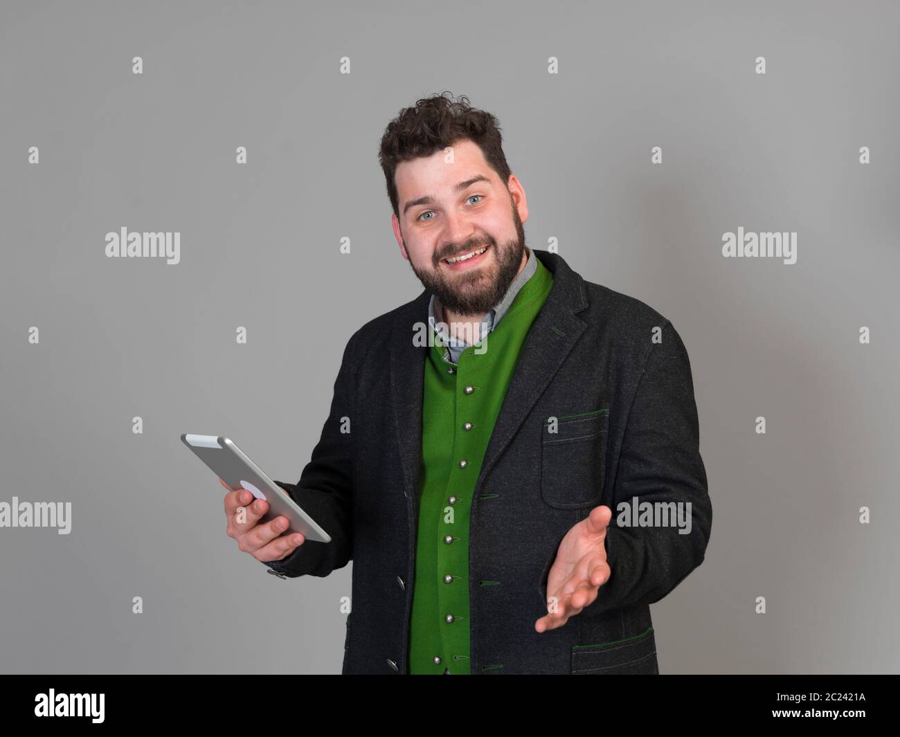 young and cool austrian man with black hair and beard in traditional ...