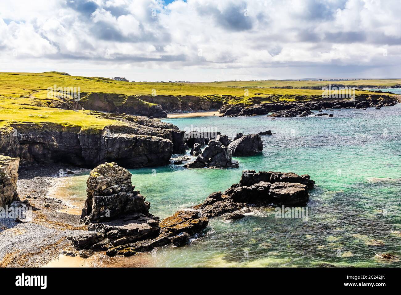 Scotland's coast with rocky, greened cliffs and mountains in the ...
