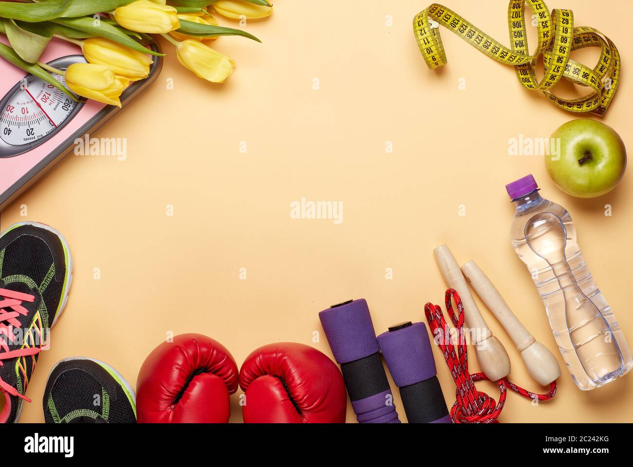 Female fitness still life. Sport accessories, tulips flowers and scales ...