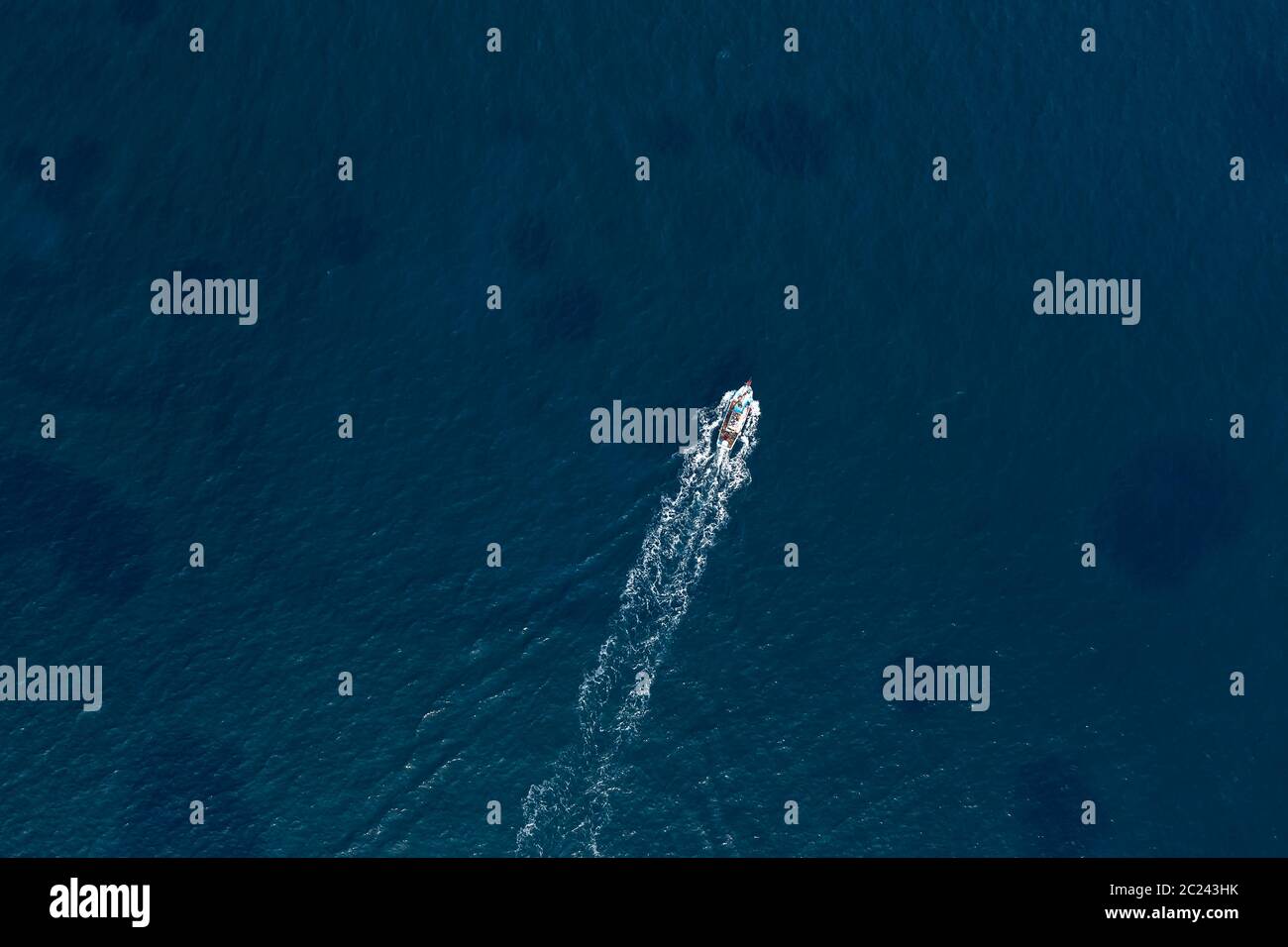 Small fishing boat in the deep blue sea. Overhead view Stock Photo - Alamy
