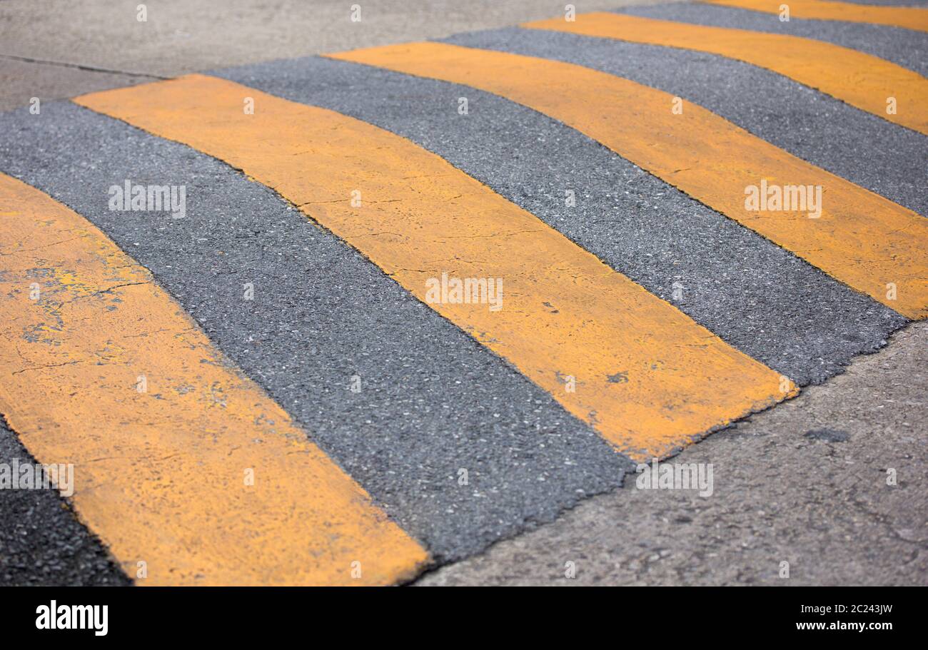 traffic safety speed bump on the road Stock Photo - Alamy