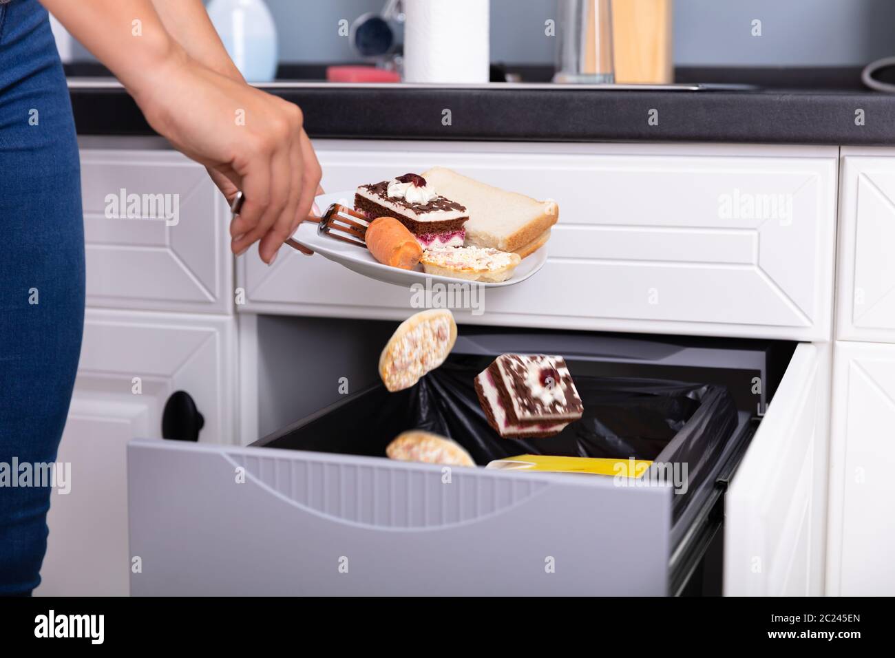 Woman throwing food in trash hi-res stock photography and images - Alamy