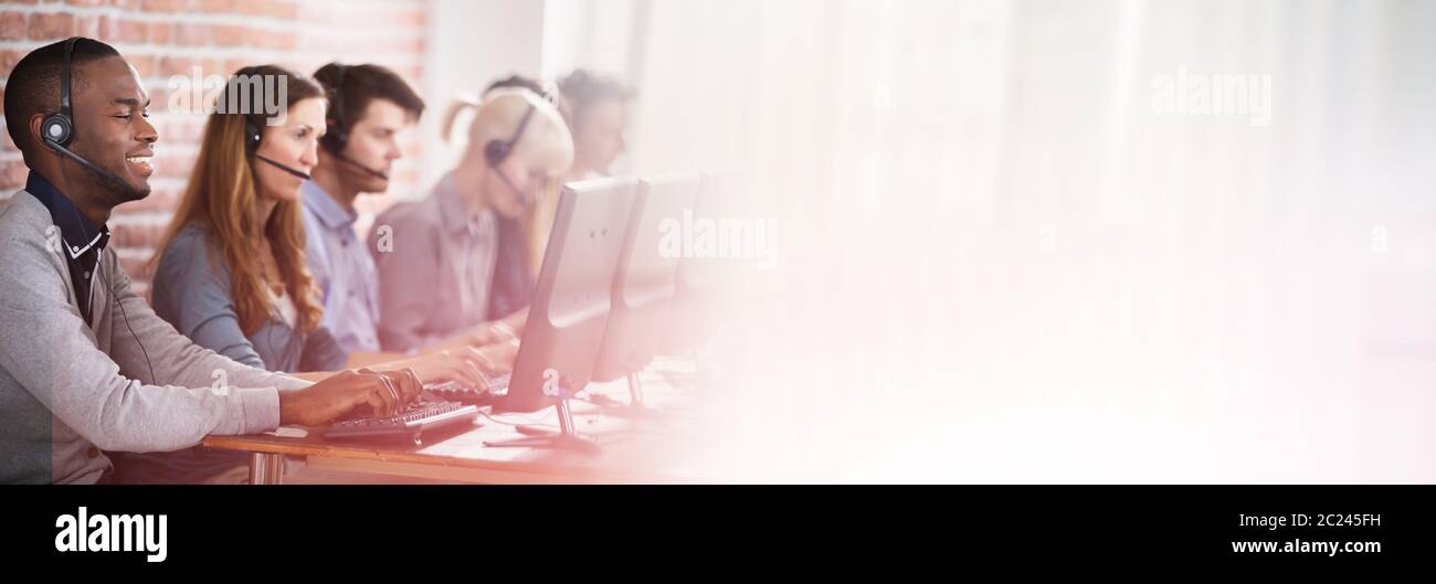 Young Customer Service Executives Using Earphones Working In Call ...