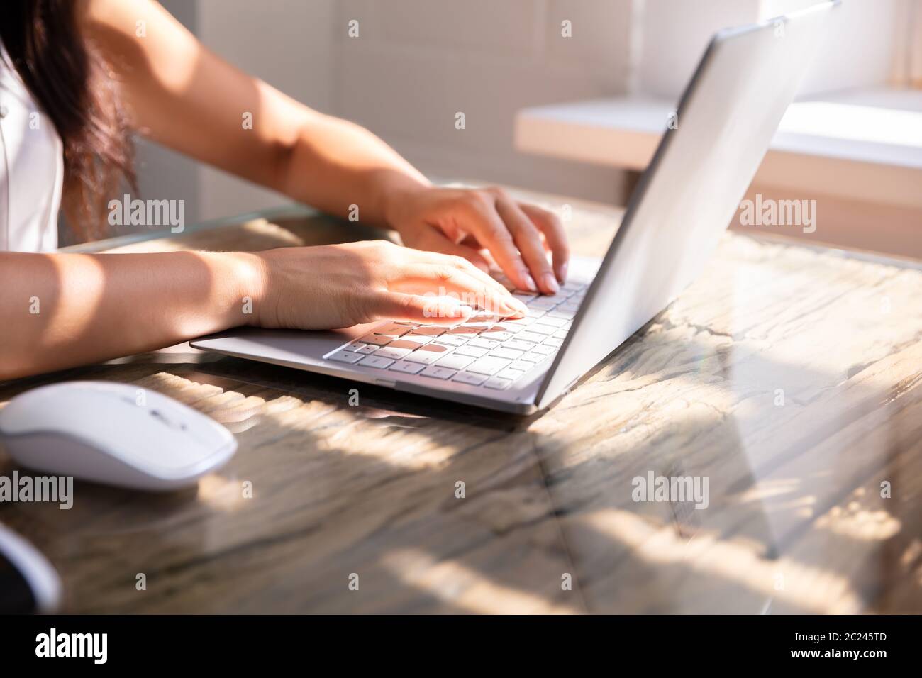Close-up Of A Person's Hand Typing On Laptop Keypad On Desk At ...