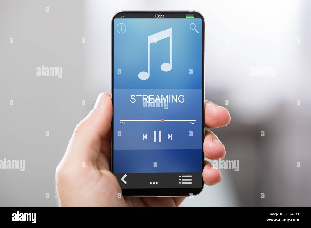 Close-up Of Person's Hand Holding Smartphone With Music Streaming On ...