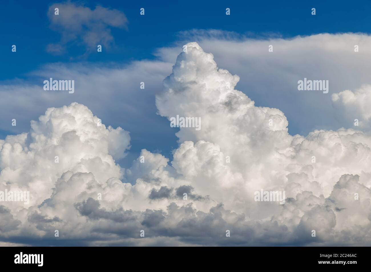 Cumulus clouds of white-gray color against a blue sky after a ...