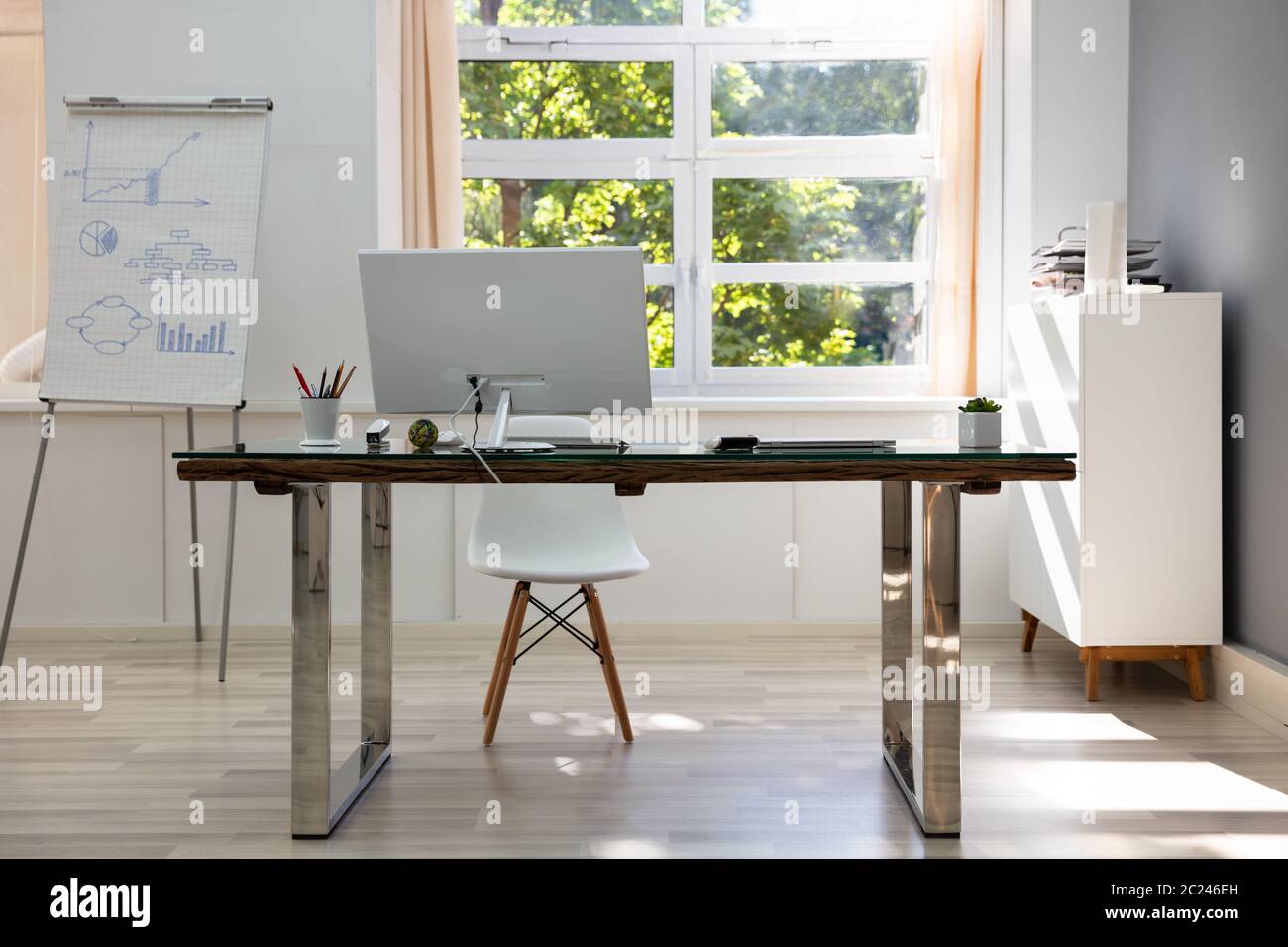 Computer On Desk In Modern Office Interior Stock Photo - Alamy