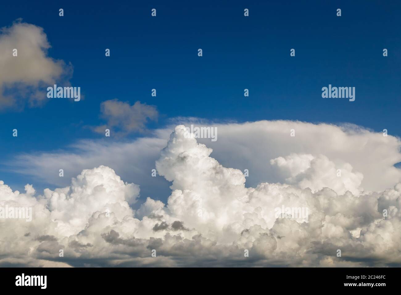 Cumulus clouds of white-gray color against a blue sky after a ...