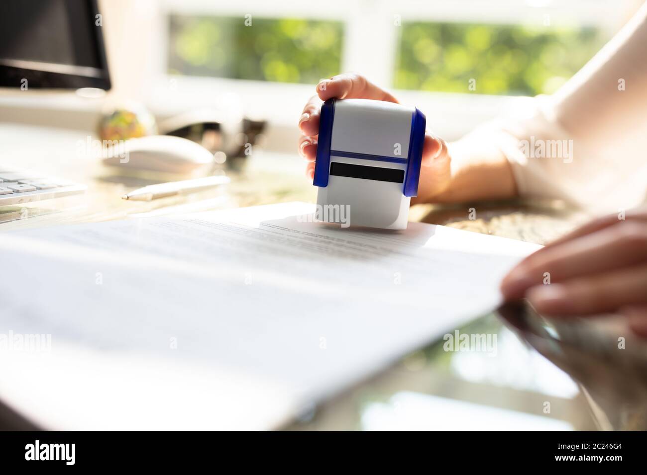 Close-up Of Businesswoman's Hand Stamping Approved On Contract Paper ...