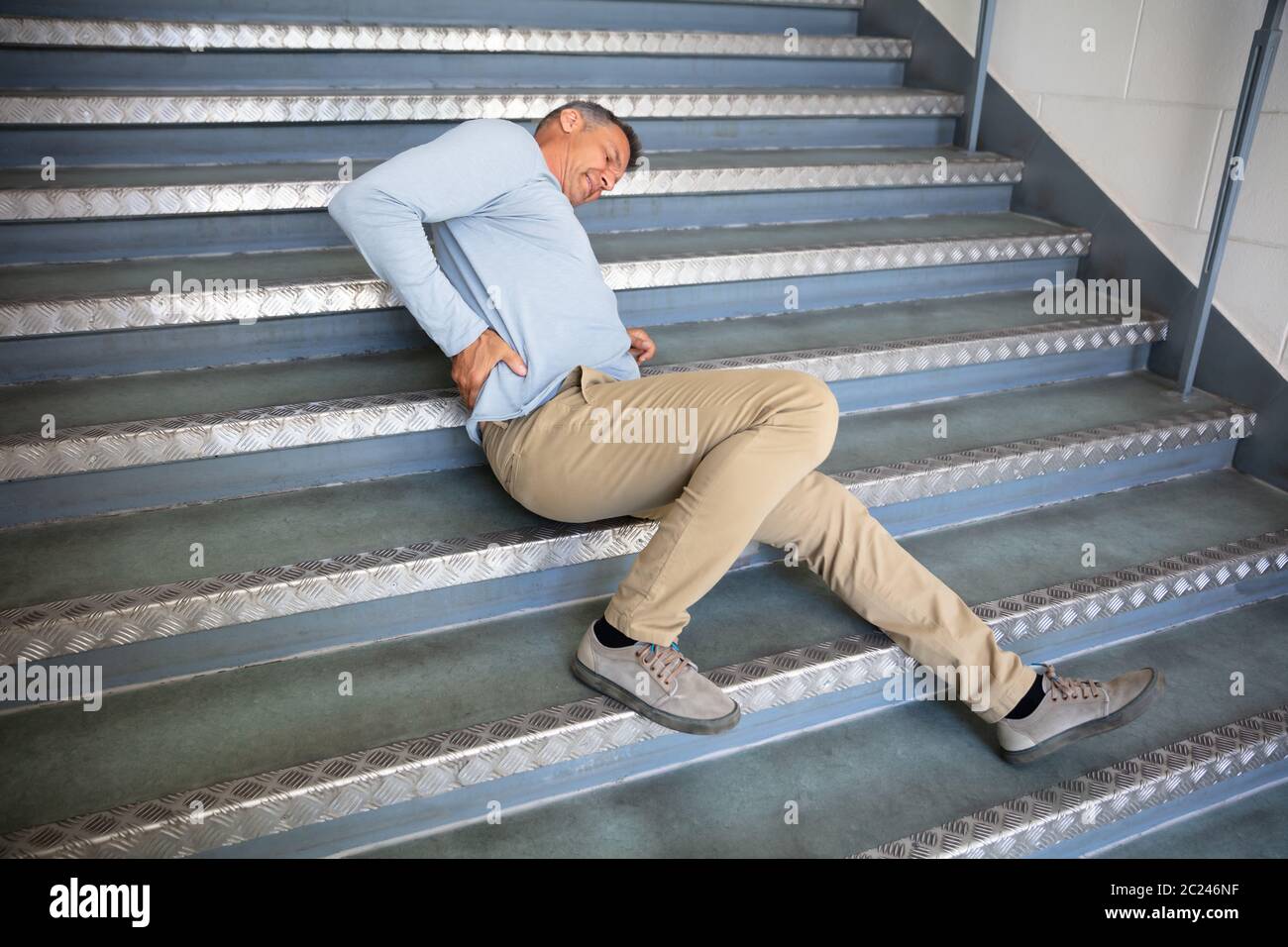 Mature Man Lying On Staircase After Slip And Fall Accident Stock Photo ...