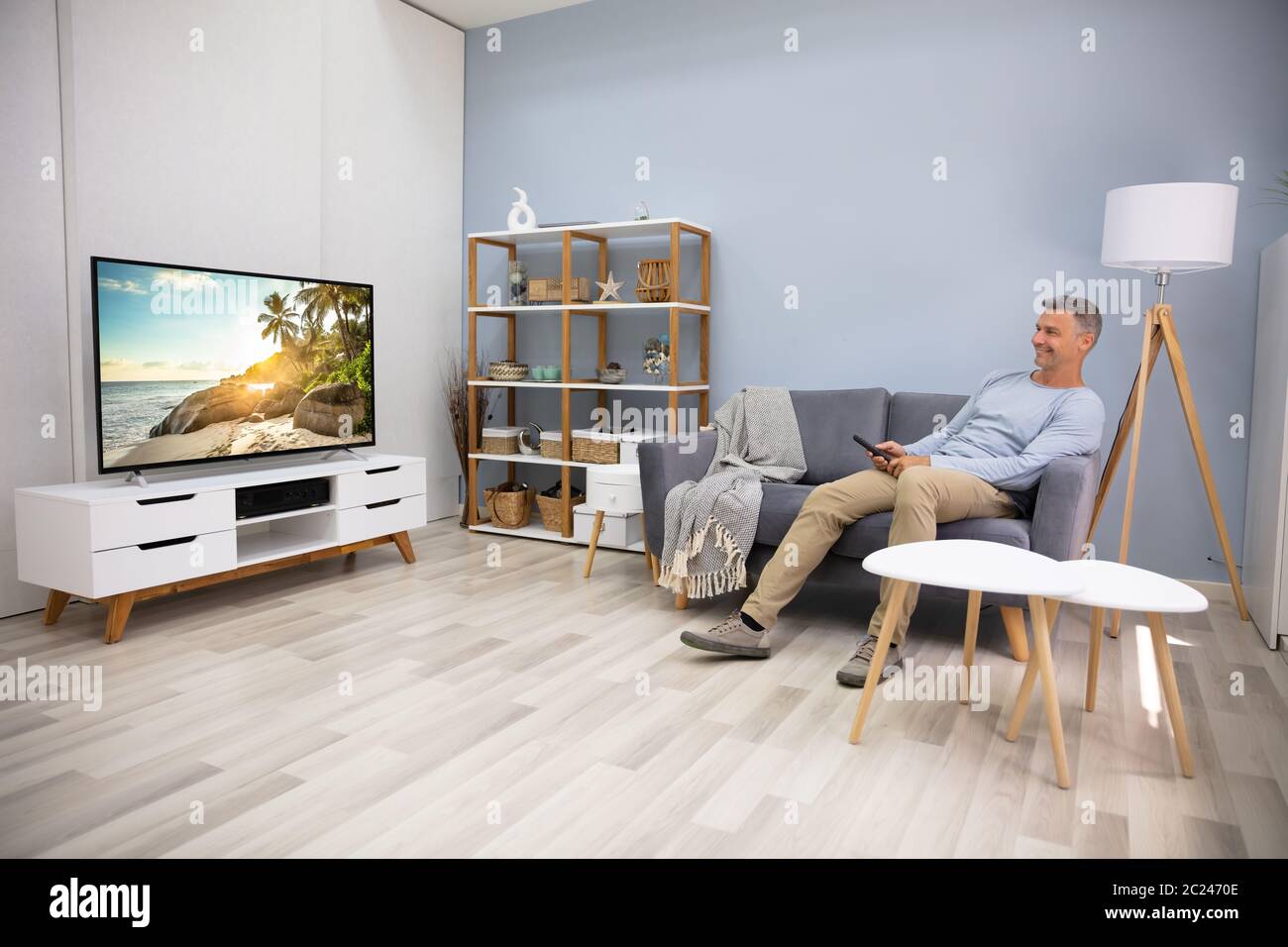 Side View Of Man Watching Television At Home Stock Photo - Alamy