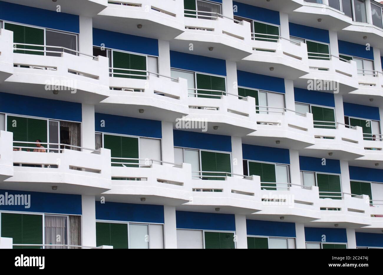 modern apartment building with white balconies and blue details with ...