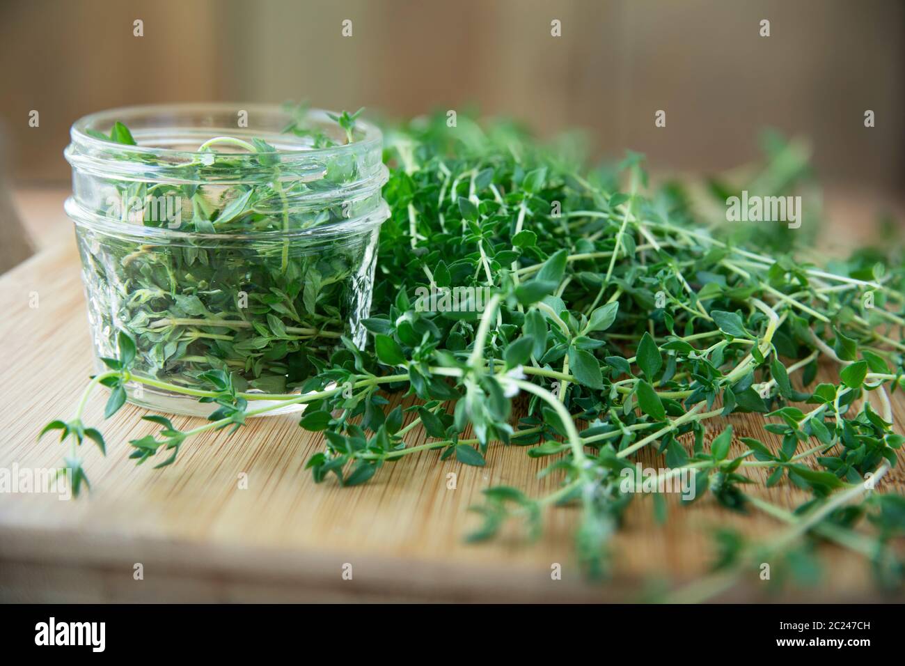 Fresh thyme and glass canning jar for pickled thyme Stock Photo - Alamy