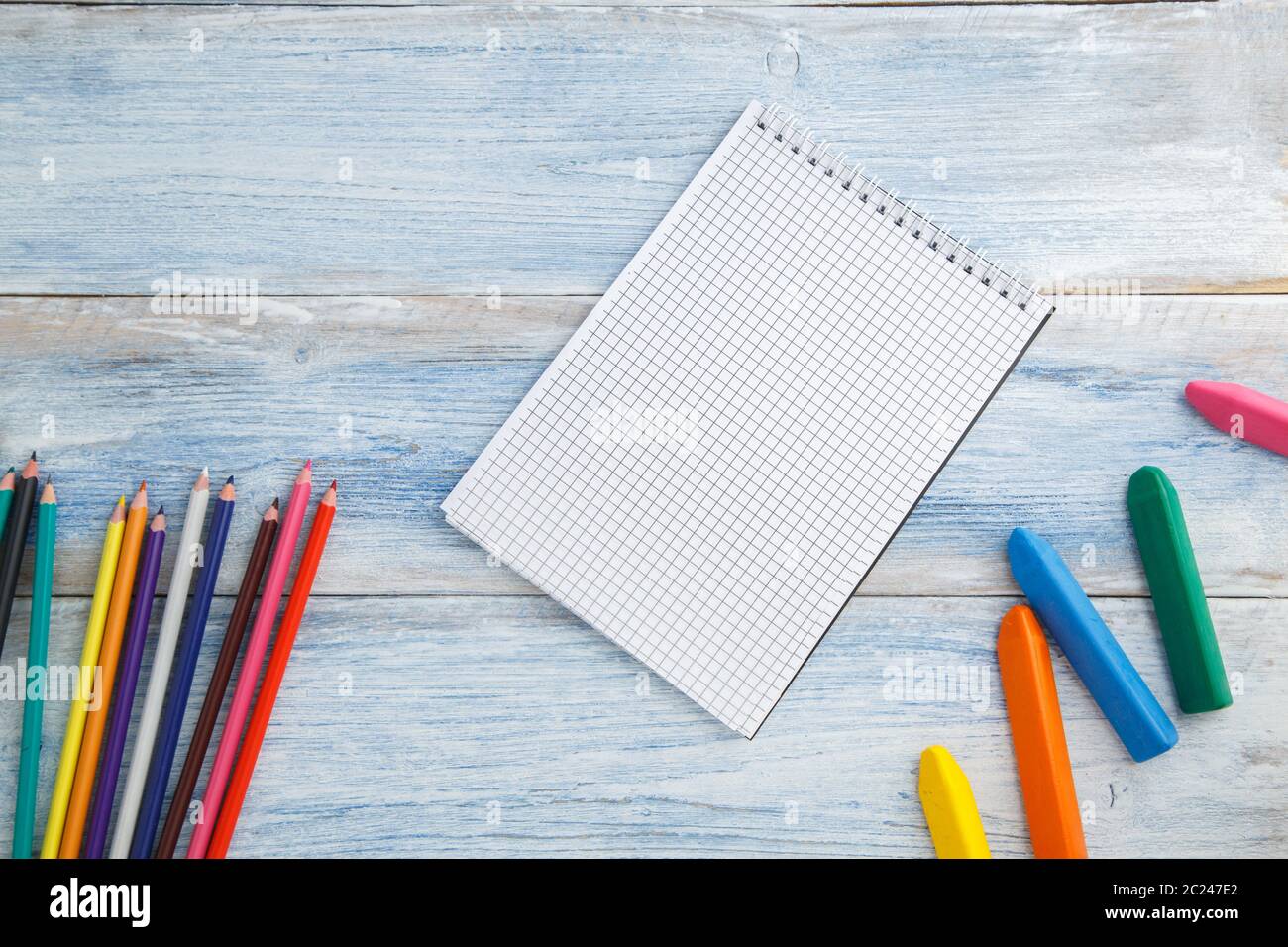 school children's concept. colored pencils or crayons and Notepad on a ...