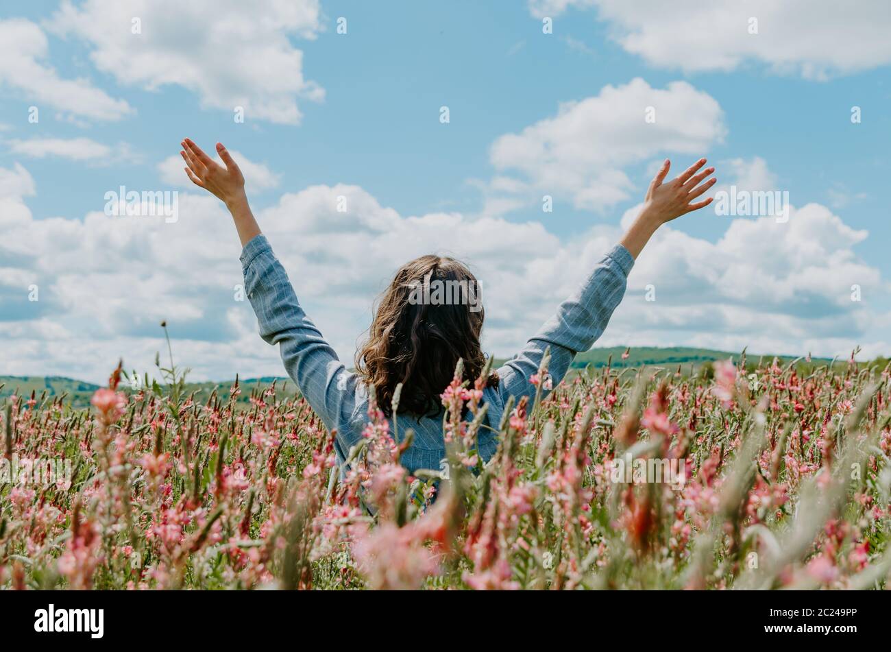 Woman arms up looking sky hi-res stock photography and images - Alamy