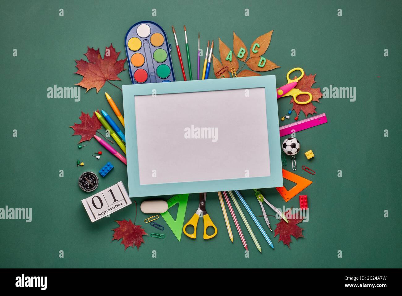 Blue frame with blank sheet and stationery accessories: pencils, pens ...