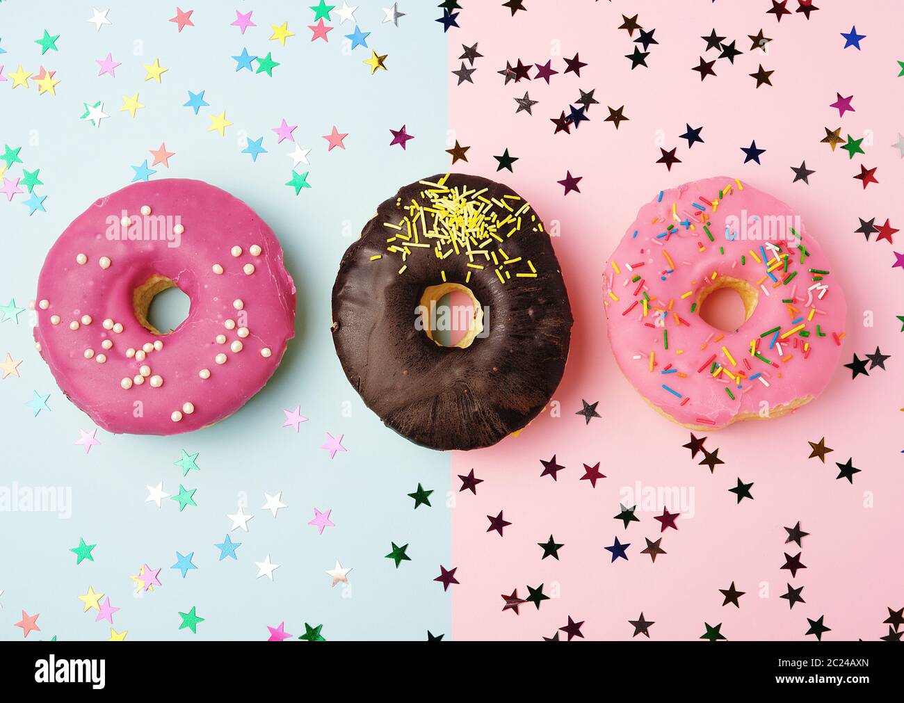 round donuts with various fillings and sprinkles on an abstract color ...