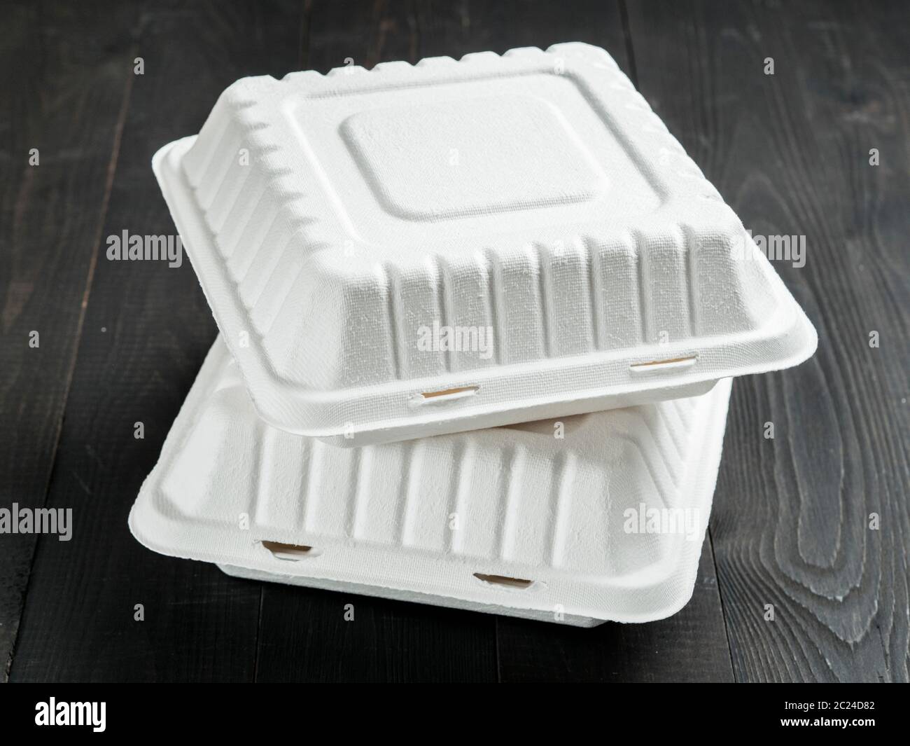 Two closed disposable take out container. Gray closed cardboard lunch ...