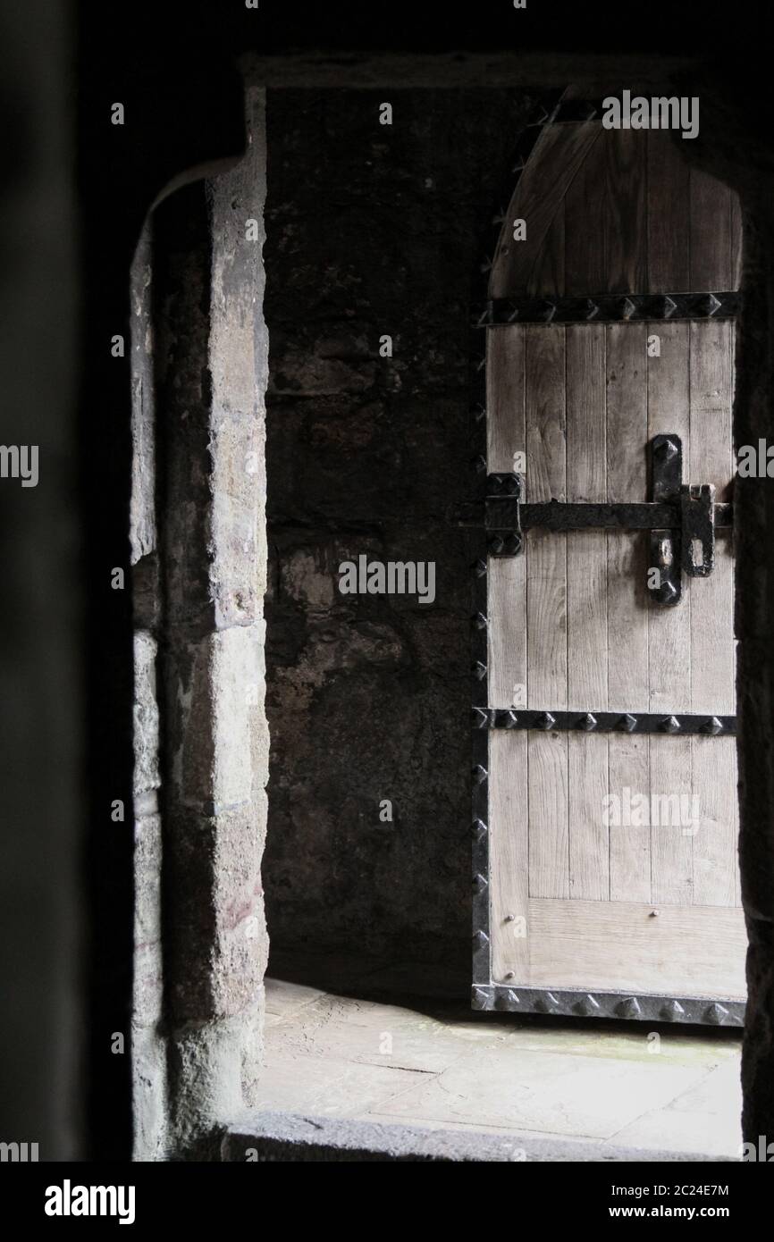 Historic heavy wooden door studded with black iron Stock Photo - Alamy