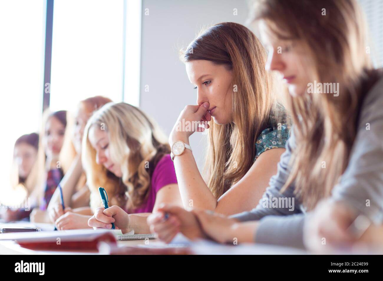 Students in classroom - young pretty female college student sitting in ...