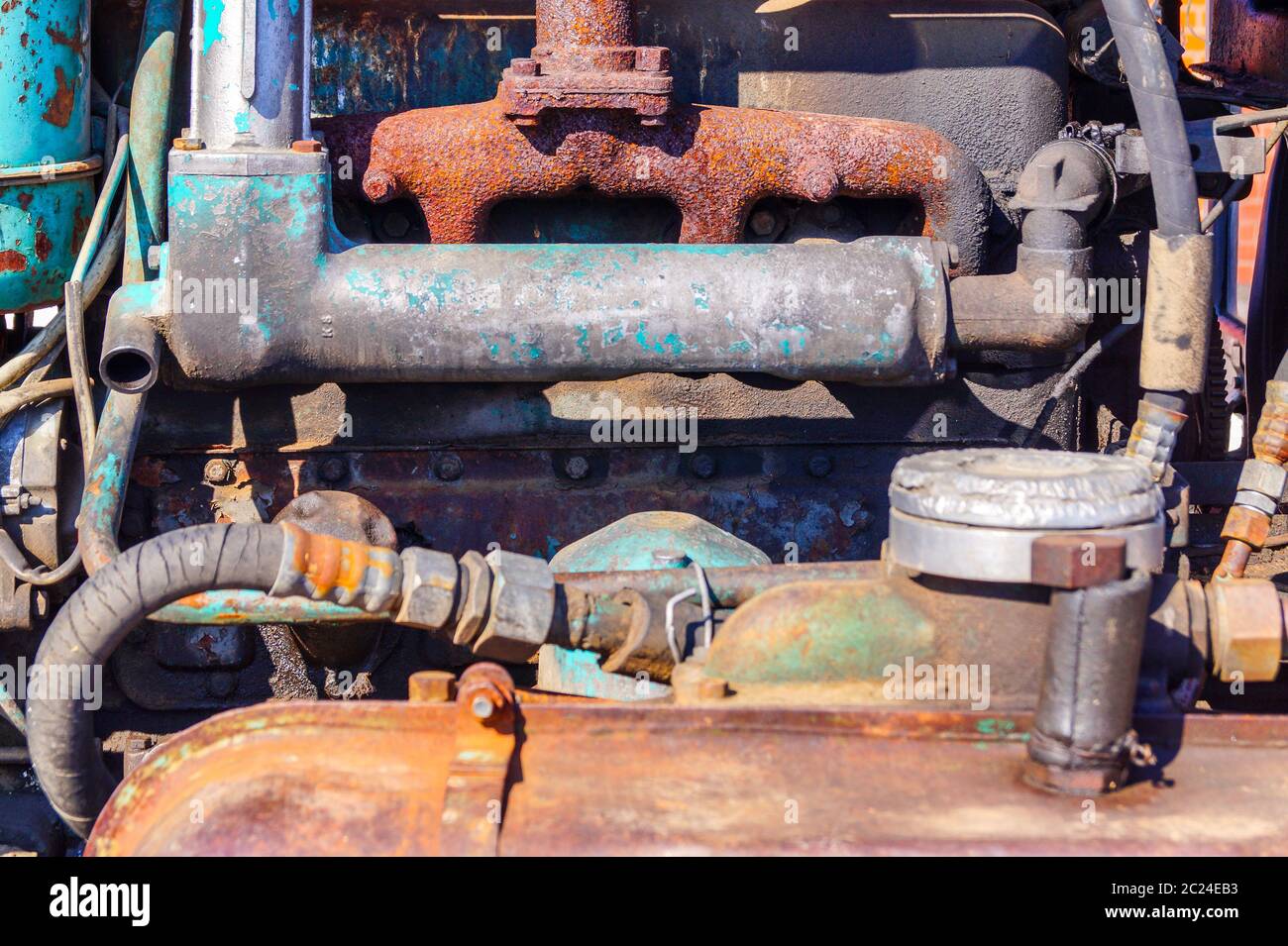 An old rusty tractor diesel engine needs repair and cleaning ...