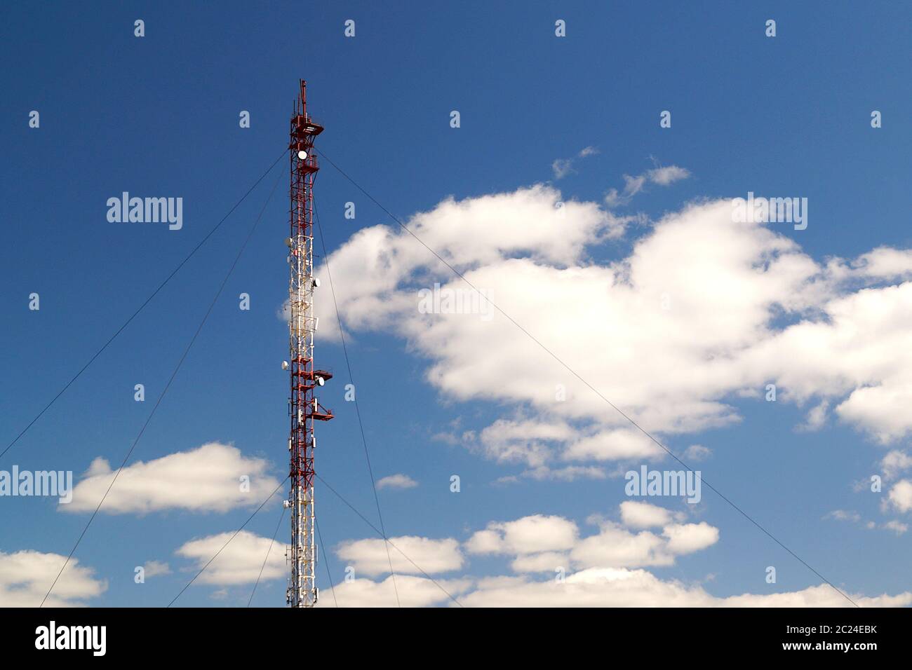 High radio television tower with antennas on a background of blue sky ...