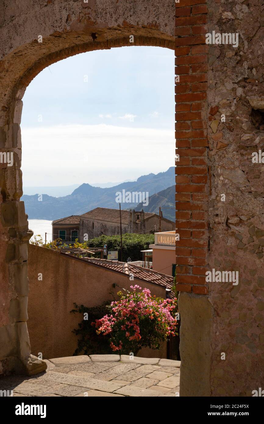 View through brick archway to typical Italian town Stock Photo - Alamy