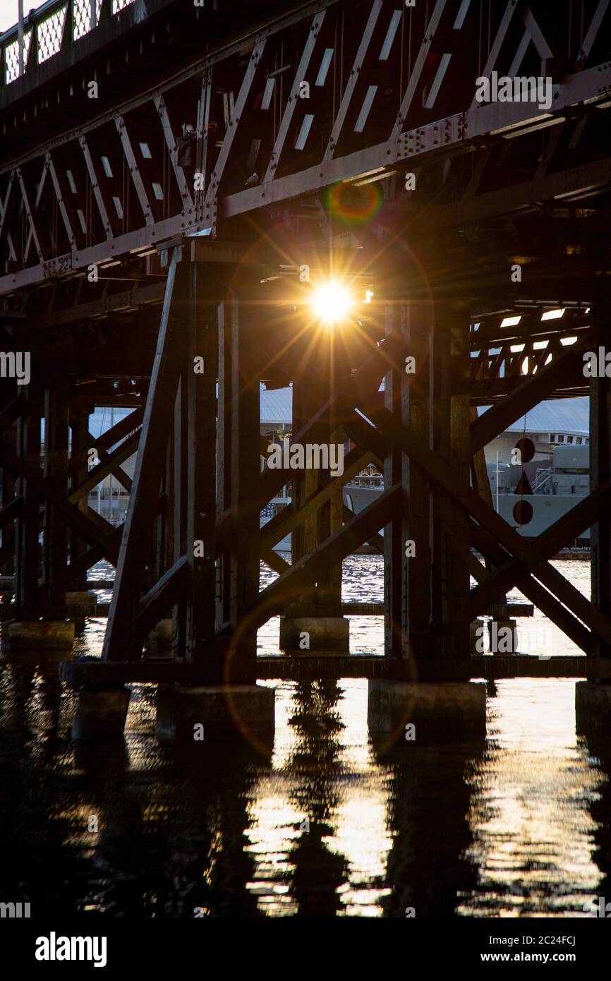 Lens flare with sunlight through construction under bridge Stock Photo ...