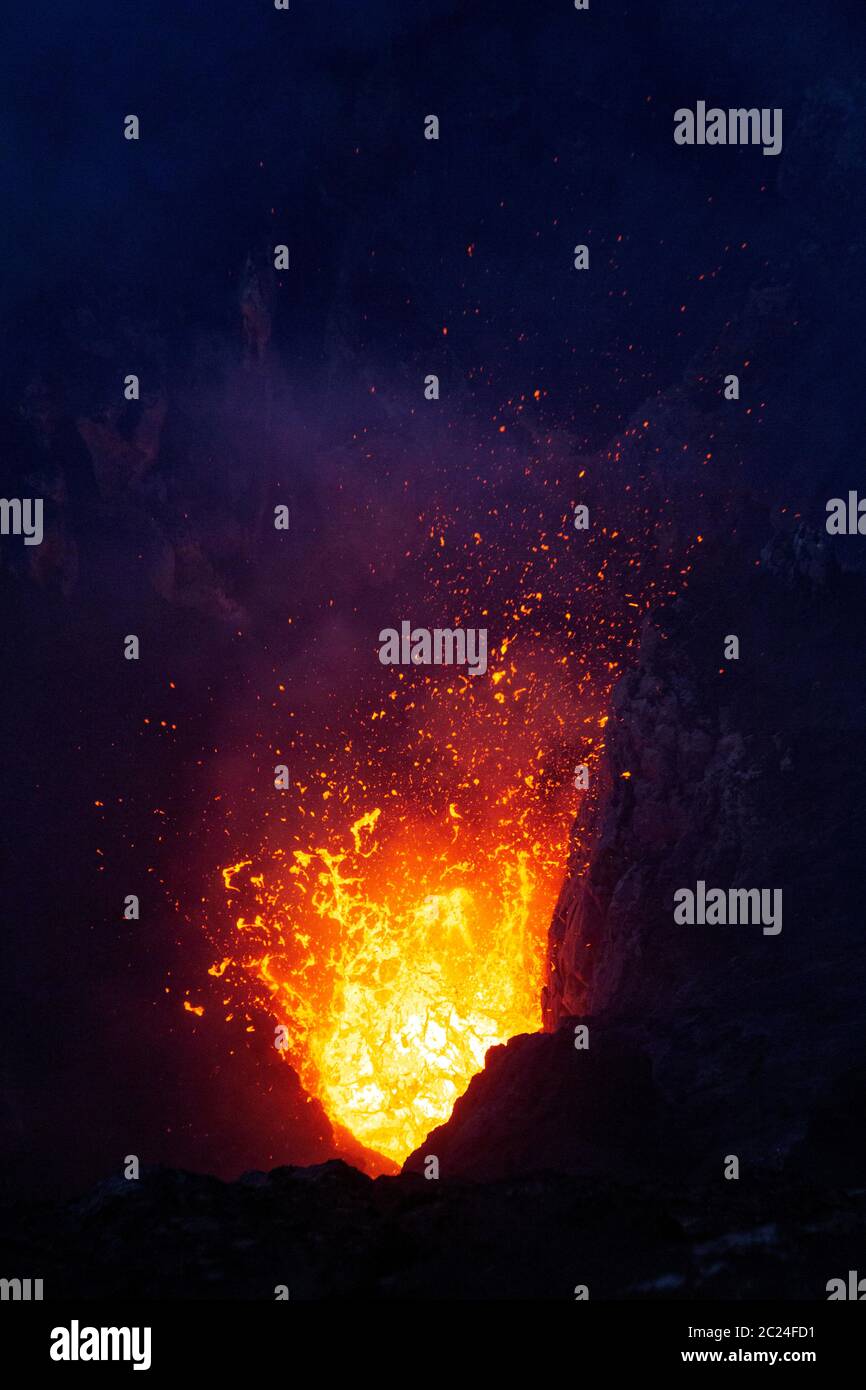 Closeup explosion in volcano spits lava and fire in darkness Stock ...