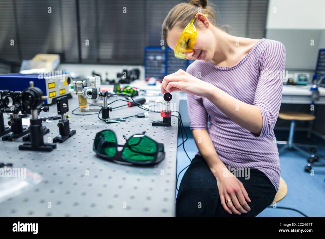 Female scientist carrying out research experiments in a quantum optics ...