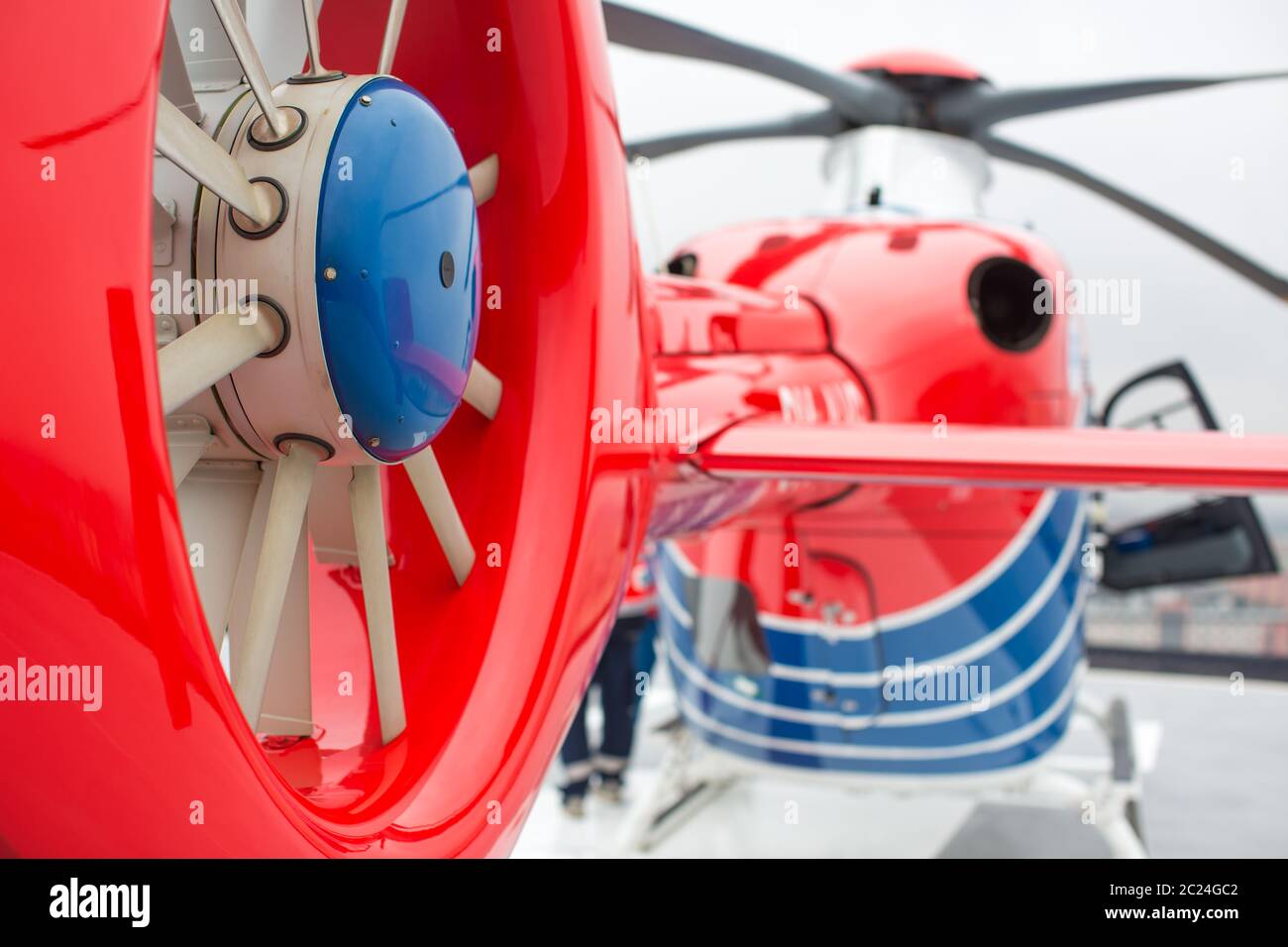 Modern medical helicopter on a hospital rooftop helipad from behind ...