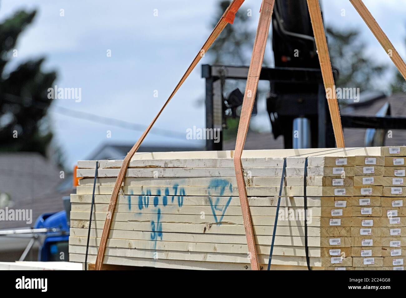 2X4 lumber being delivered to a residential house construction site ...