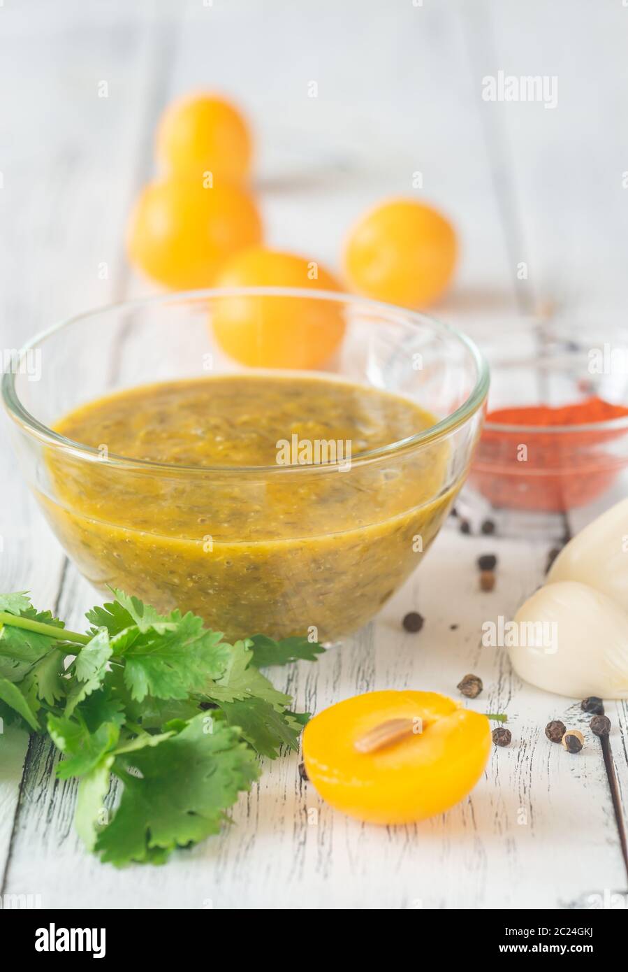 Bowl of tkemali - Georgian plum sauce with the ingredients Stock Photo ...