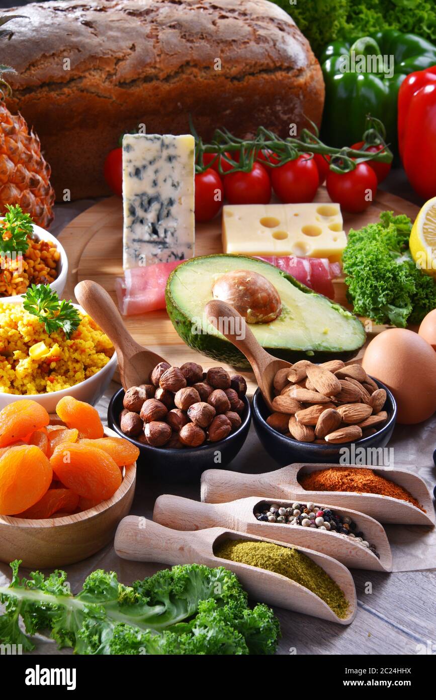 Composition with assorted food products on kitchen table Stock Photo ...