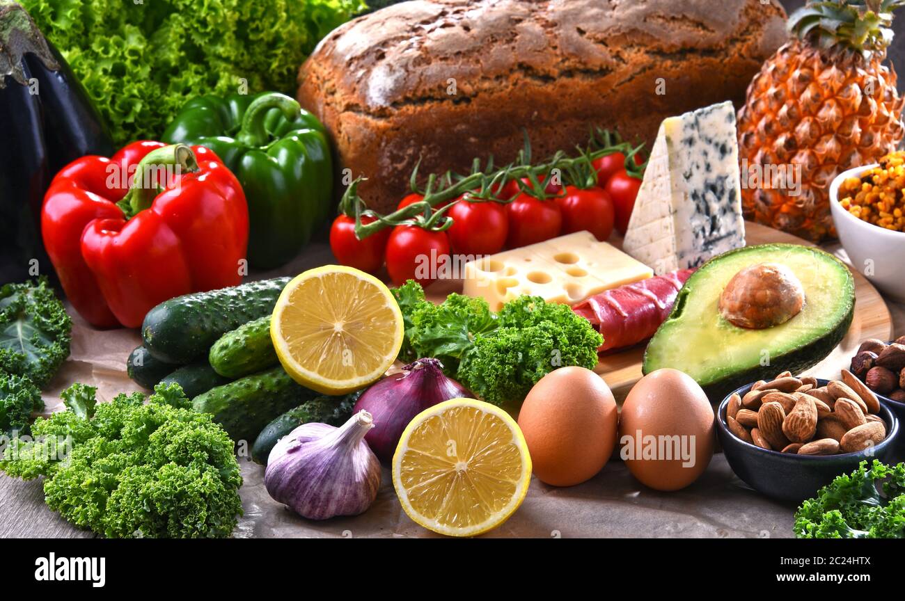 Composition with assorted food products on kitchen table Stock Photo ...